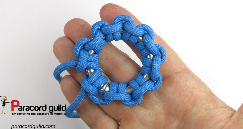 Ringbolt hitching using cow hitches - Paracord guild